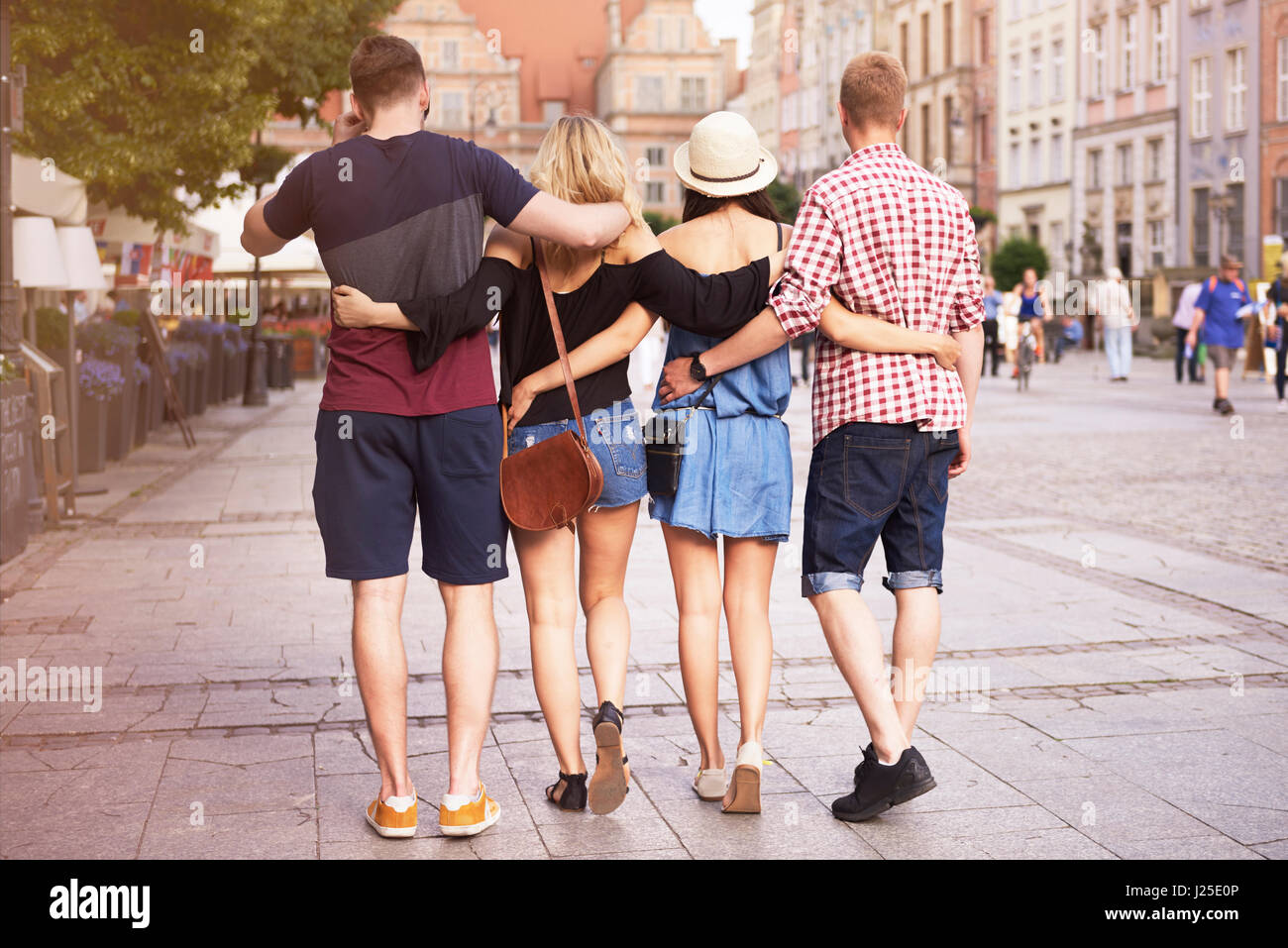 Rear view of couples walking on the streets Stock Photo - Alamy