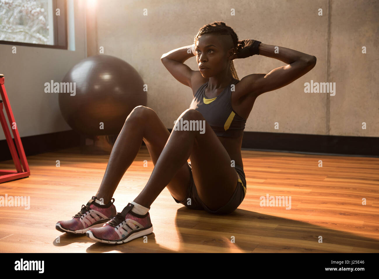 Fit woman performing fitness exercise in the gym Stock Photo - Alamy