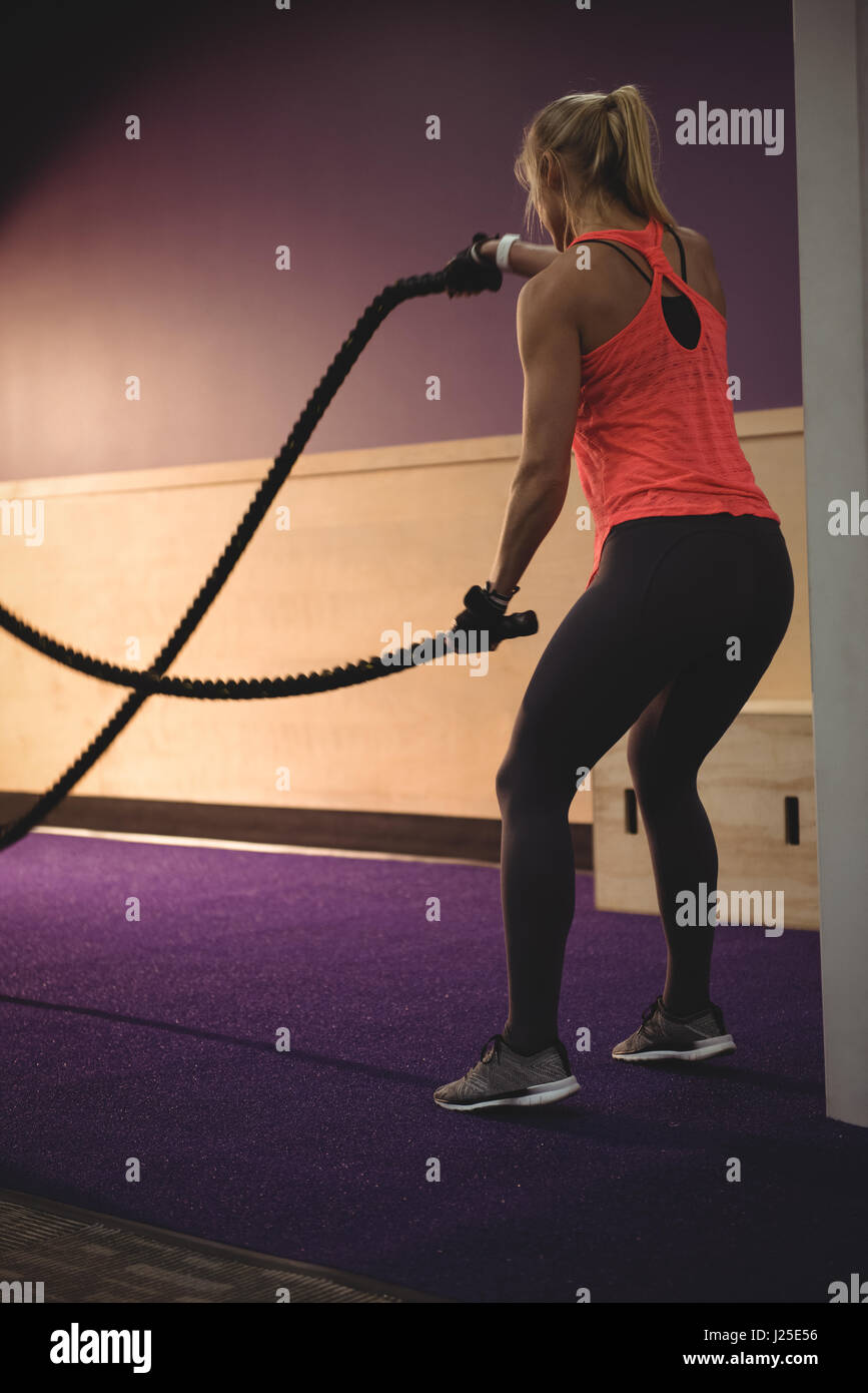 Woman doing battle rope hi-res stock photography and images - Alamy