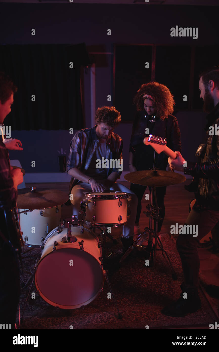 Band mates performing together in recording studio Stock Photo - Alamy