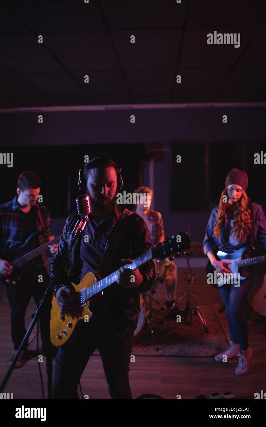 Band mates performing together in recording studio Stock Photo - Alamy