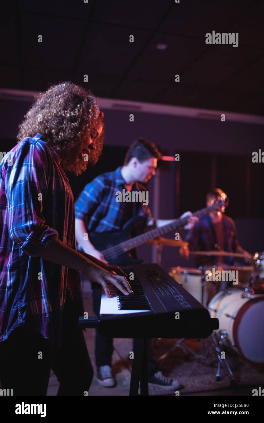Band mates performing together in the recording studio Stock Photo - Alamy