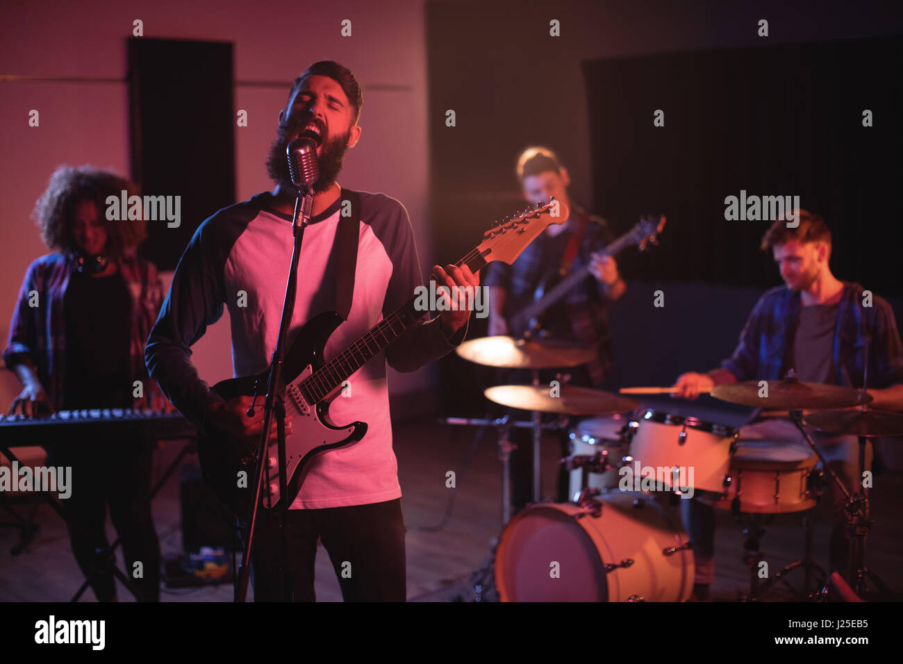 Band performing in recording studio Stock Photo - Alamy