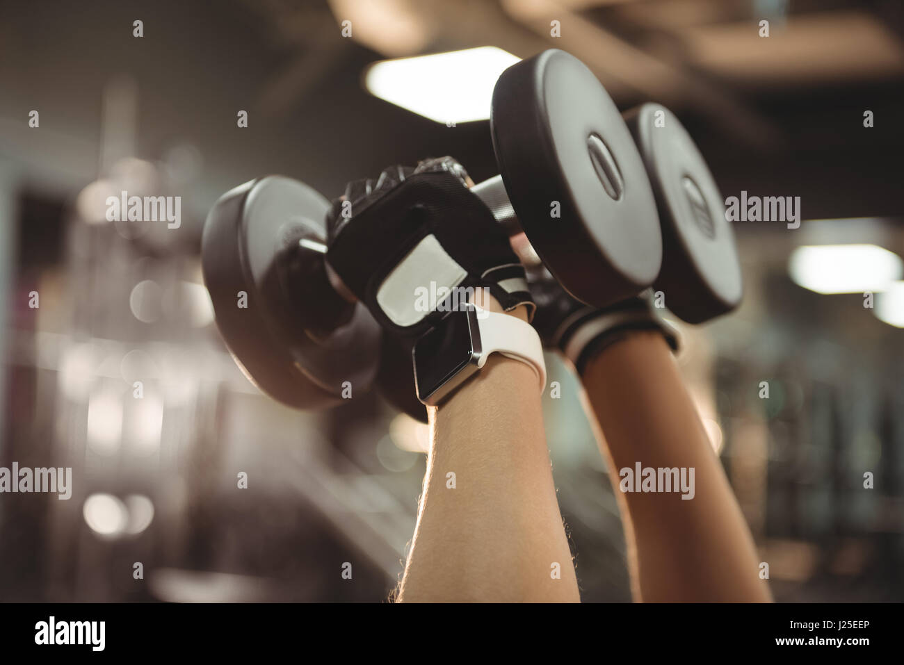 Hands of fit woman exercising with dumbbells in the gym Stock Photo - Alamy