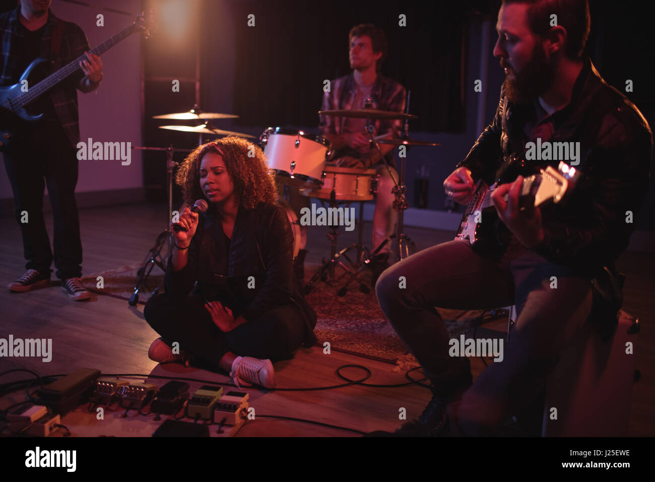Band mates performing together in recording studio Stock Photo - Alamy