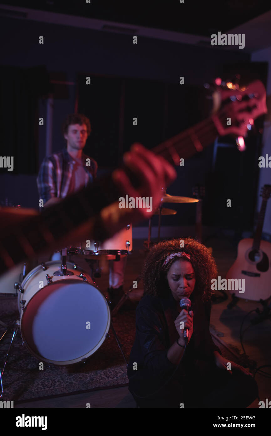 Band mates performing together in recording studio Stock Photo - Alamy