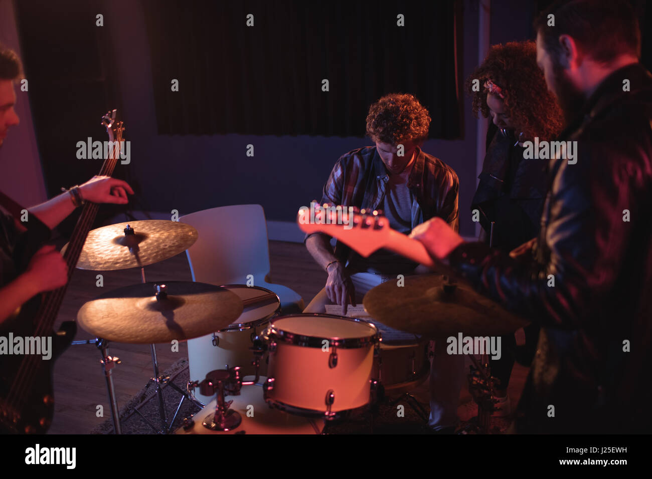 Band mates performing together in recording studio Stock Photo - Alamy