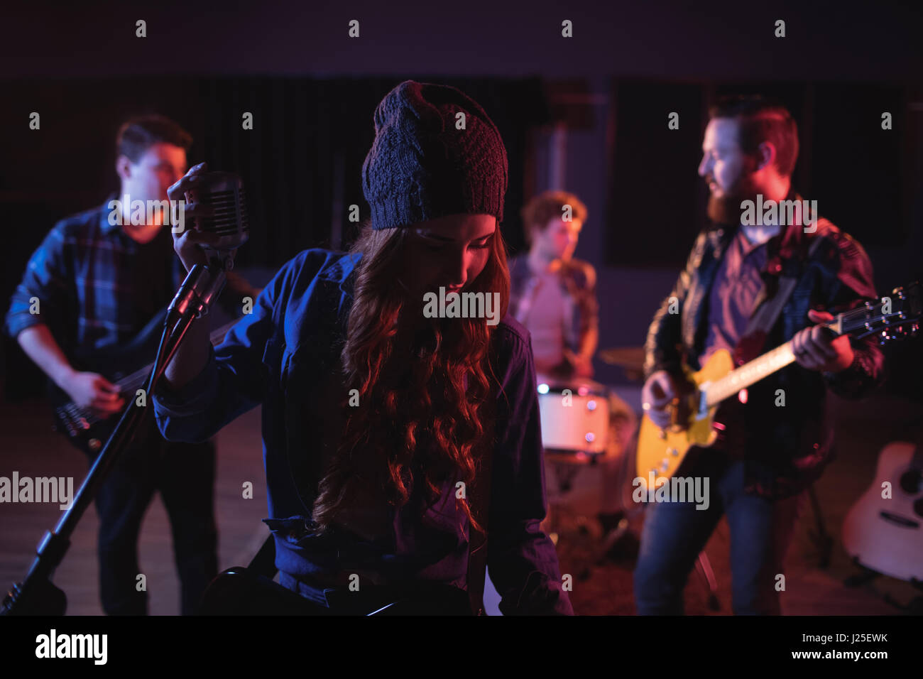 Band mates performing together in recording studio Stock Photo - Alamy