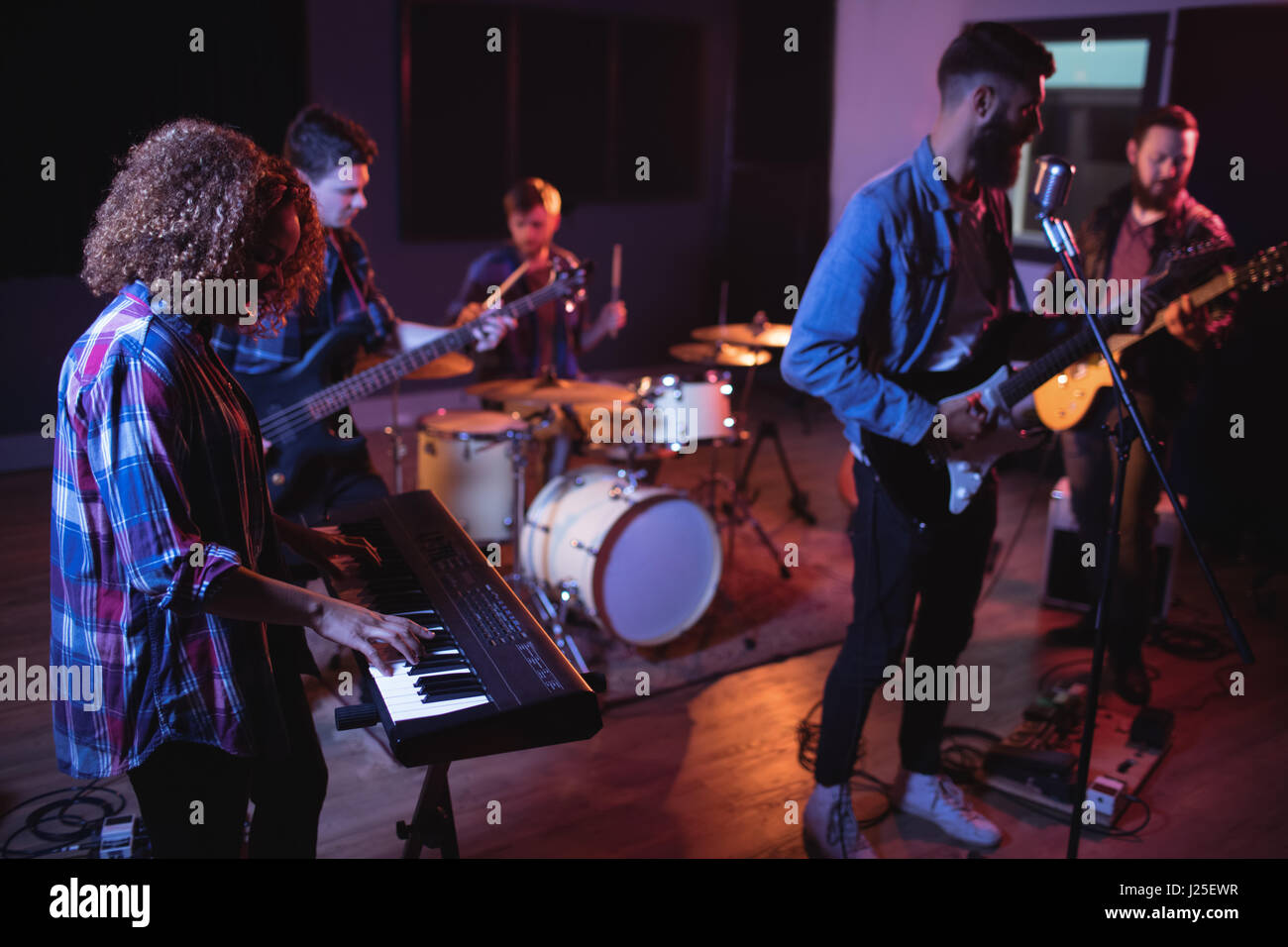 Band mates performing together in the recording studio Stock Photo - Alamy