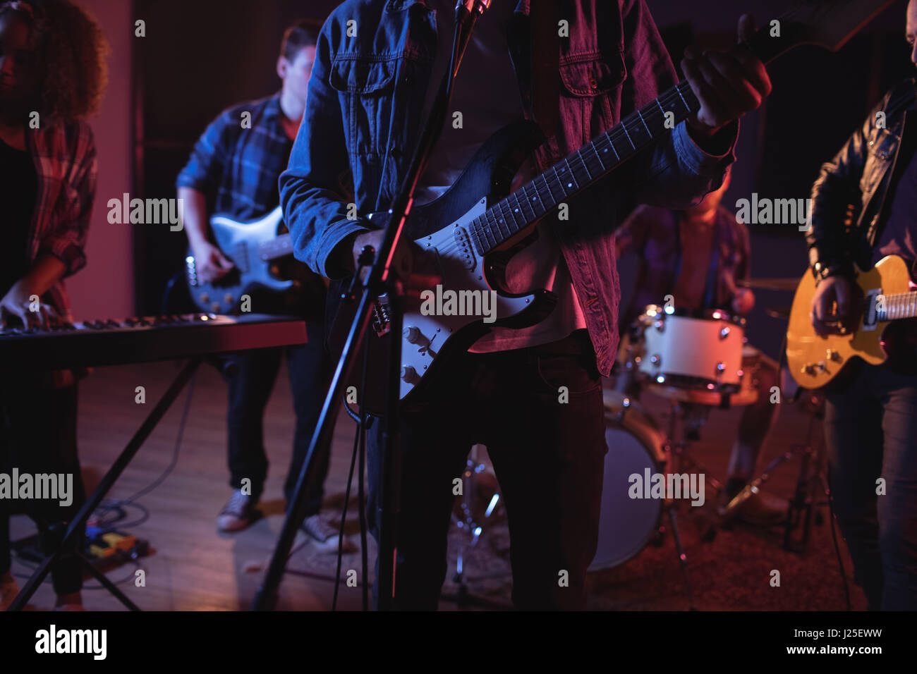 Band performing in recording studio Stock Photo - Alamy