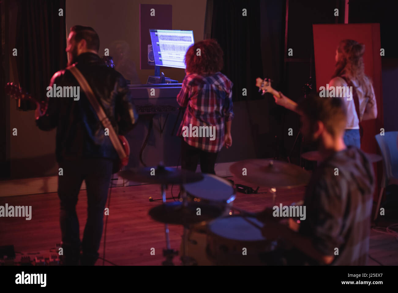 Rear view of band performing in recording studio Stock Photo - Alamy