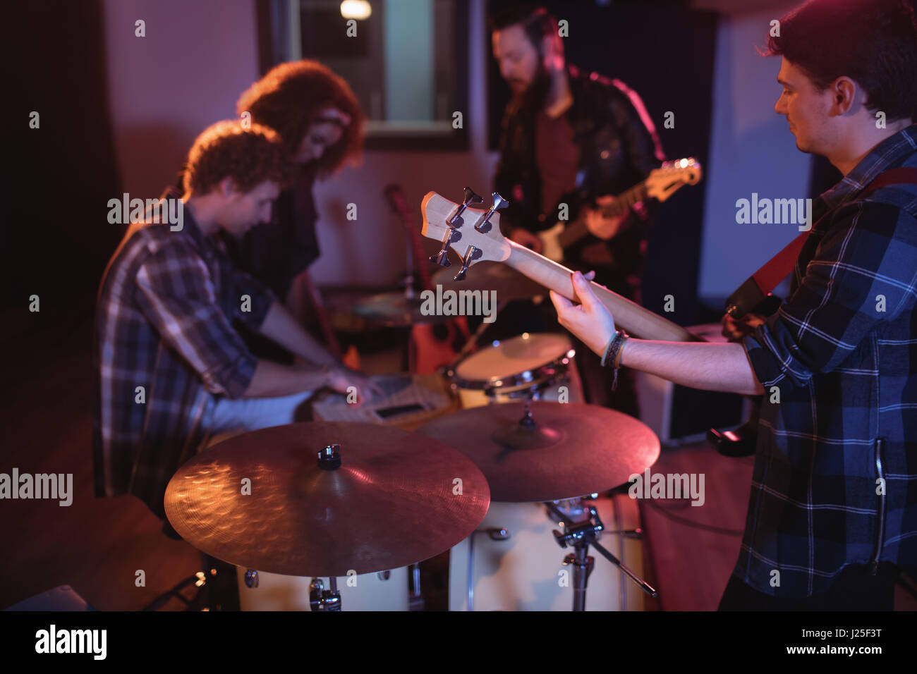 Band mates performing together in recording studio Stock Photo - Alamy