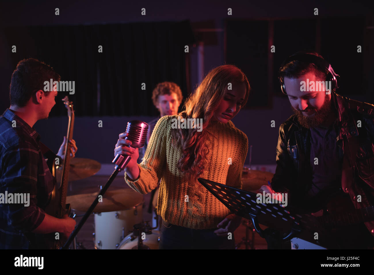 Band mates performing together in recording studio Stock Photo - Alamy