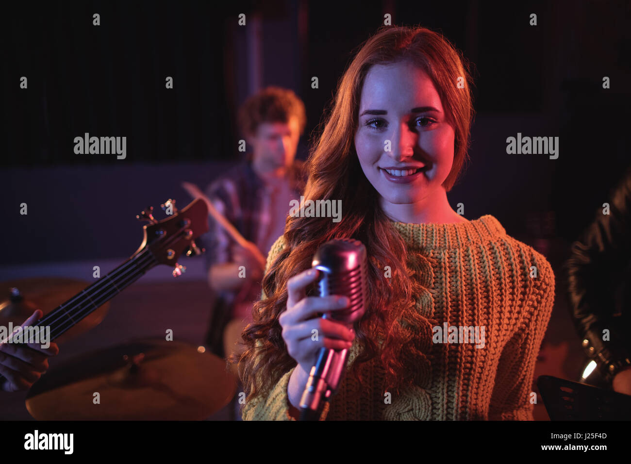 Band mates performing together in recording studio Stock Photo - Alamy