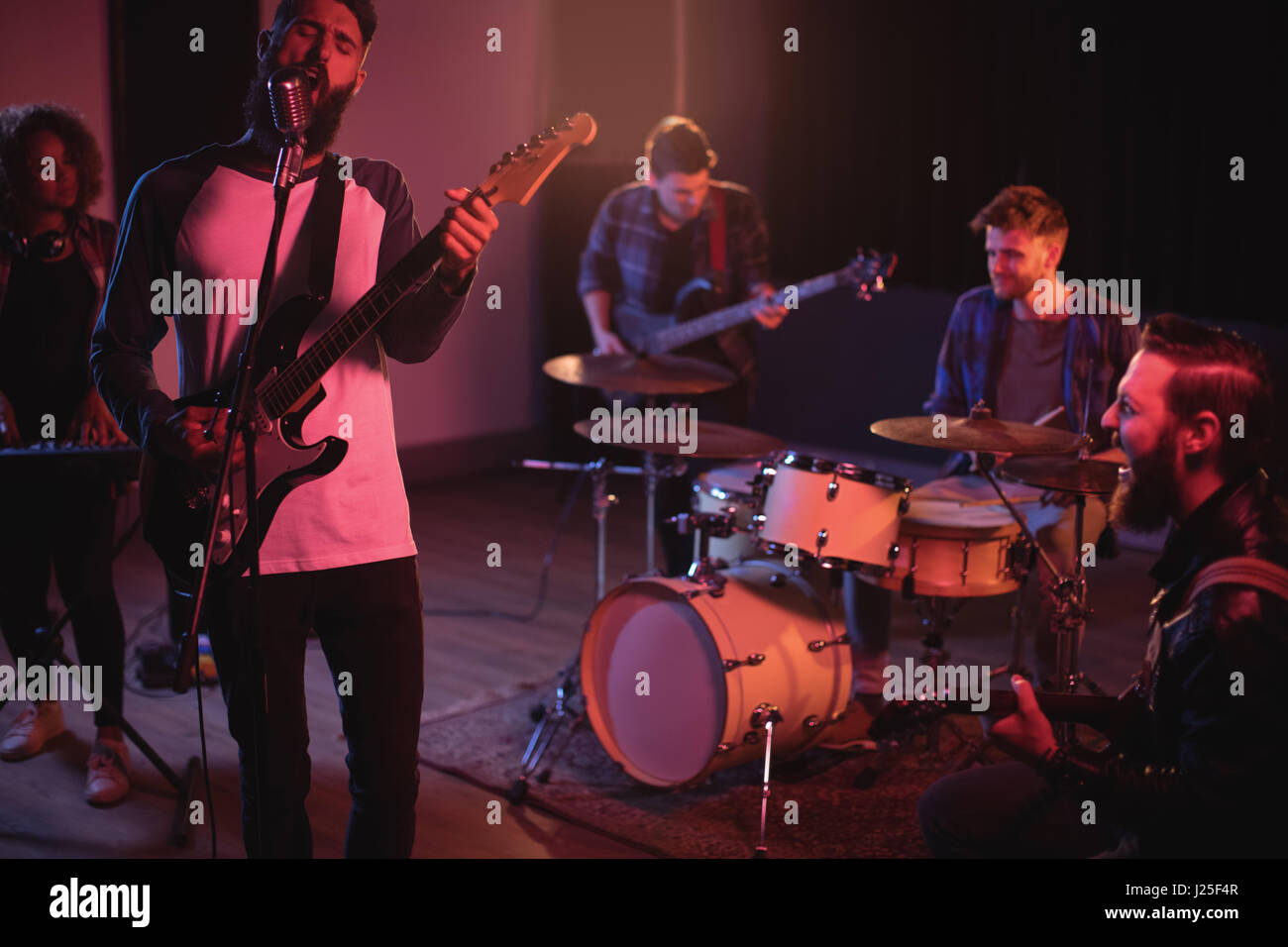 Rear view of band performing in recording studio Stock Photo - Alamy