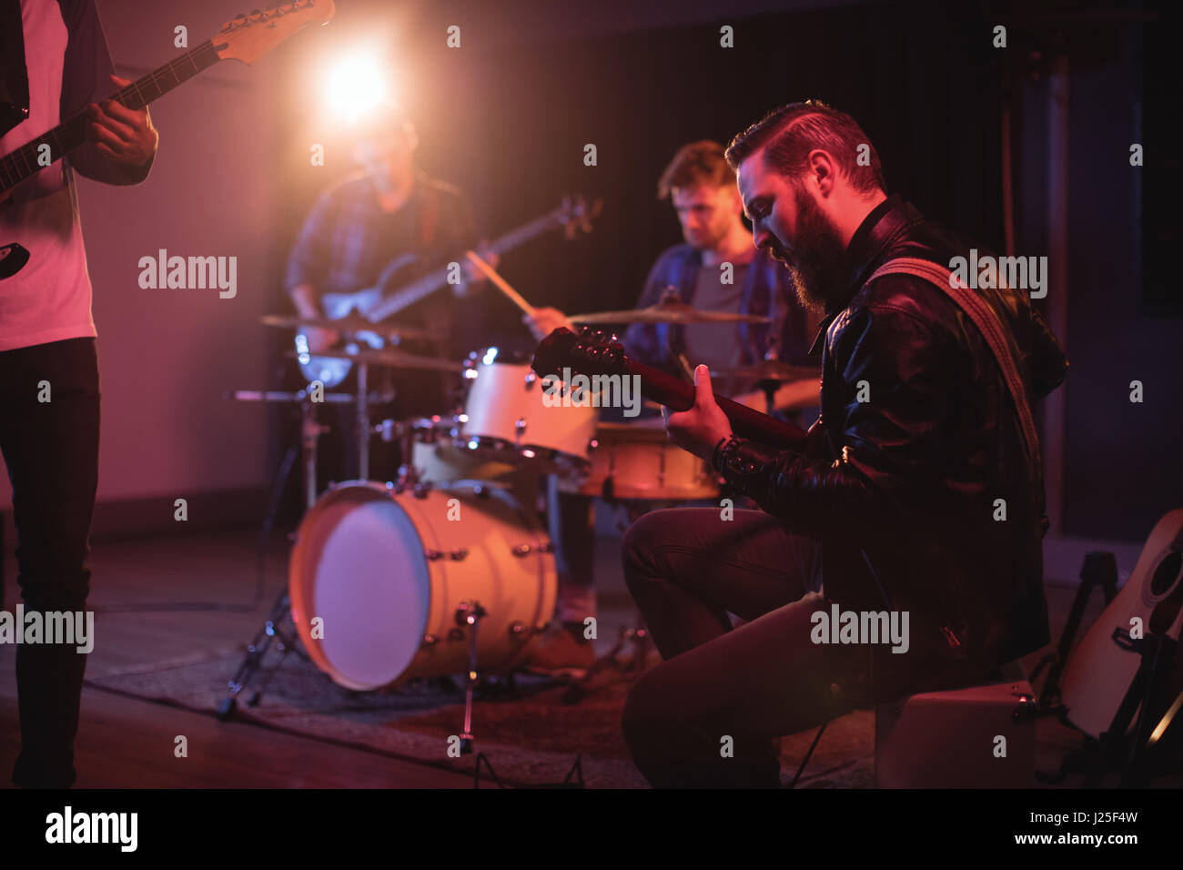 Rear view of band performing in recording studio Stock Photo - Alamy