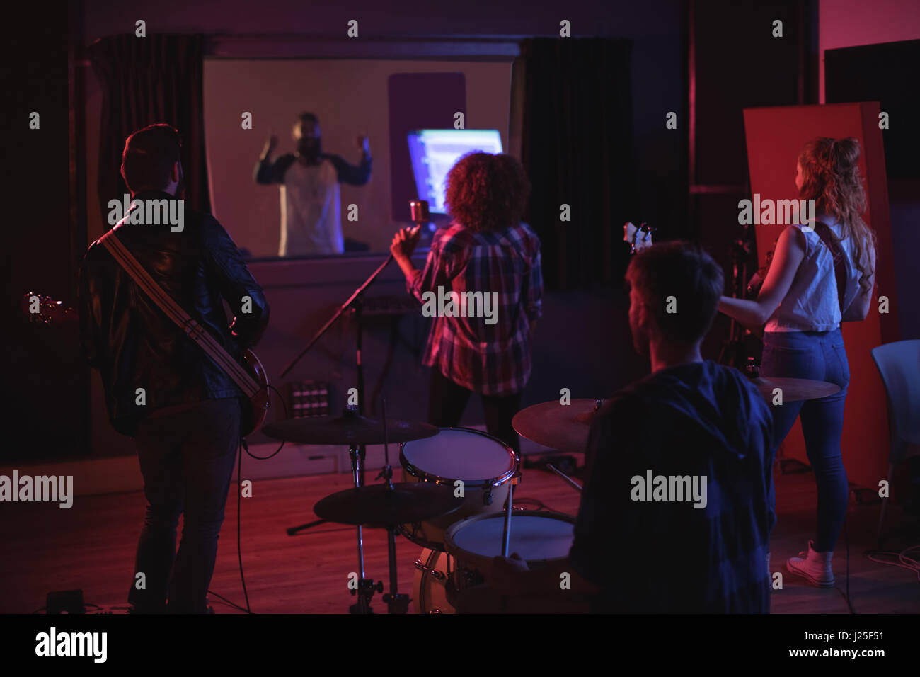 Rear view of band performing in recording studio Stock Photo - Alamy