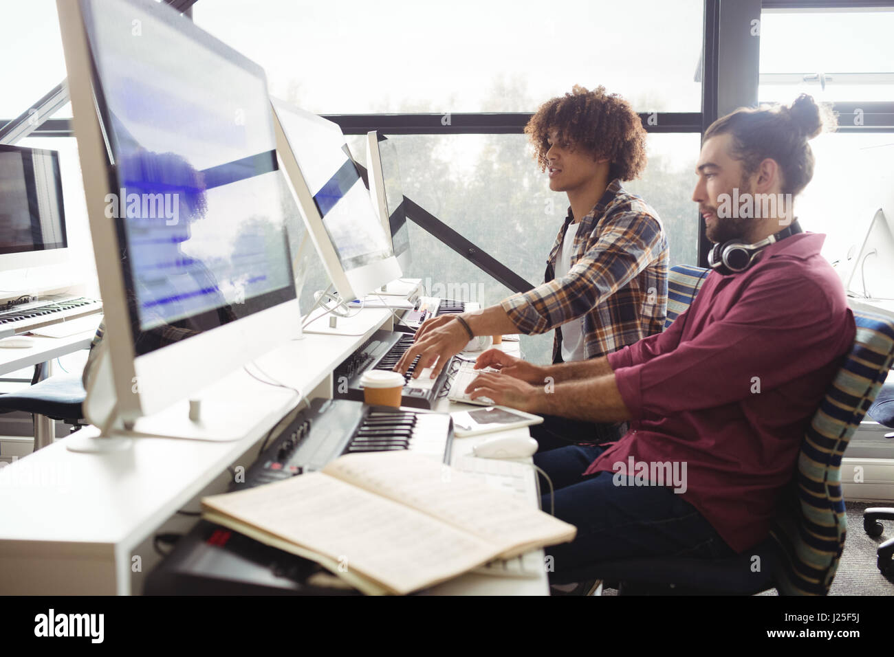Two sound engineers working together in studio Stock Photo - Alamy