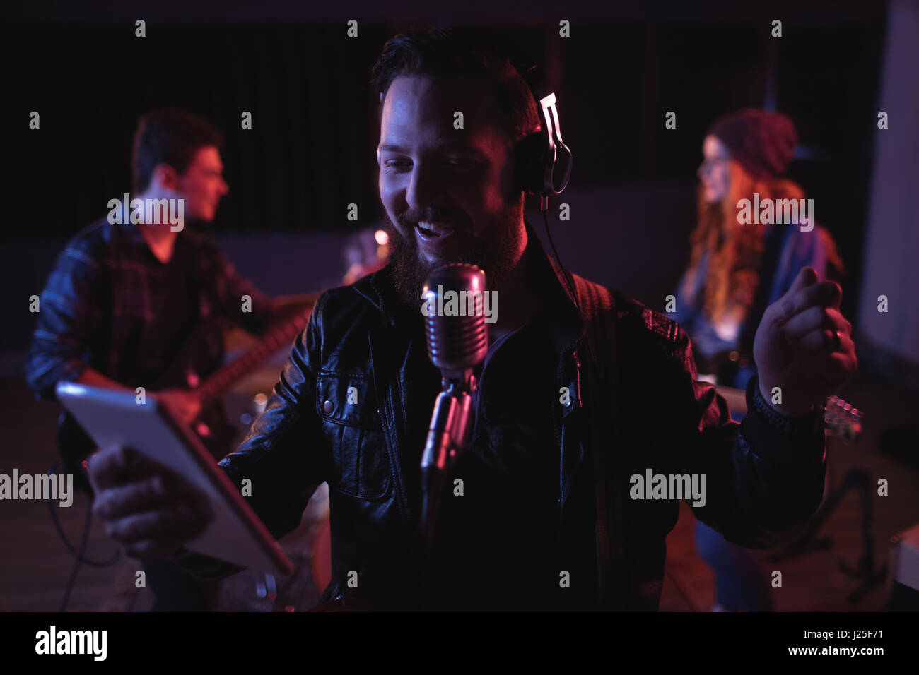 Man singing on retro microphone in recording studio Stock Photo - Alamy