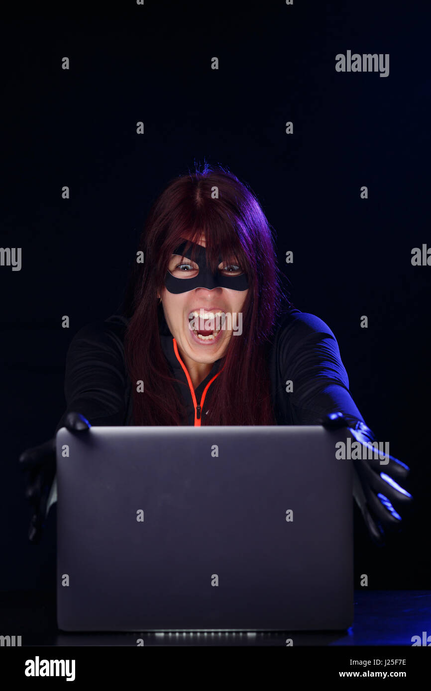 Screaming brunette hacker at night Stock Photo - Alamy