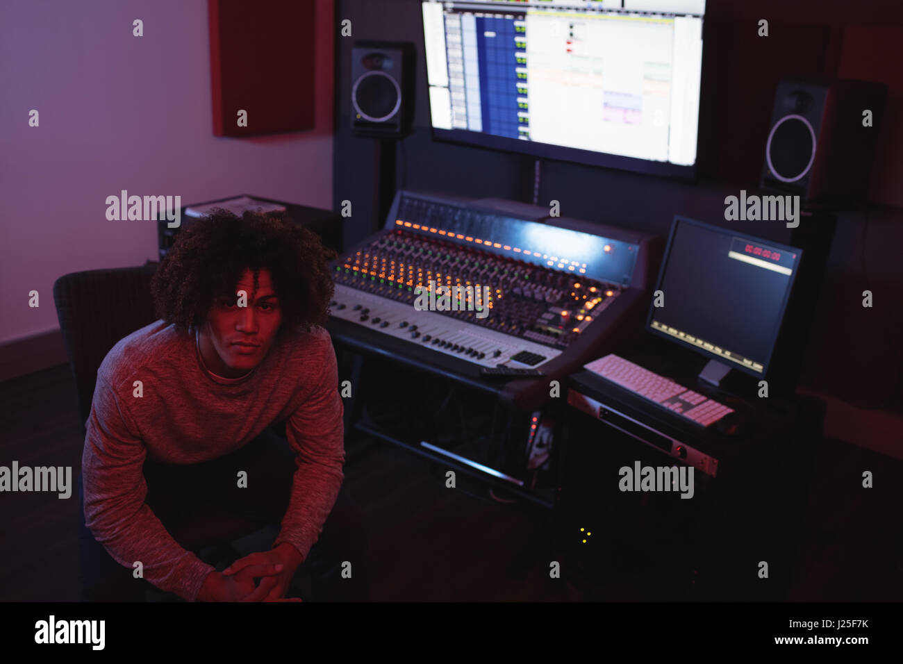Portrait of male audio engineer sitting in recording studio Stock Photo ...