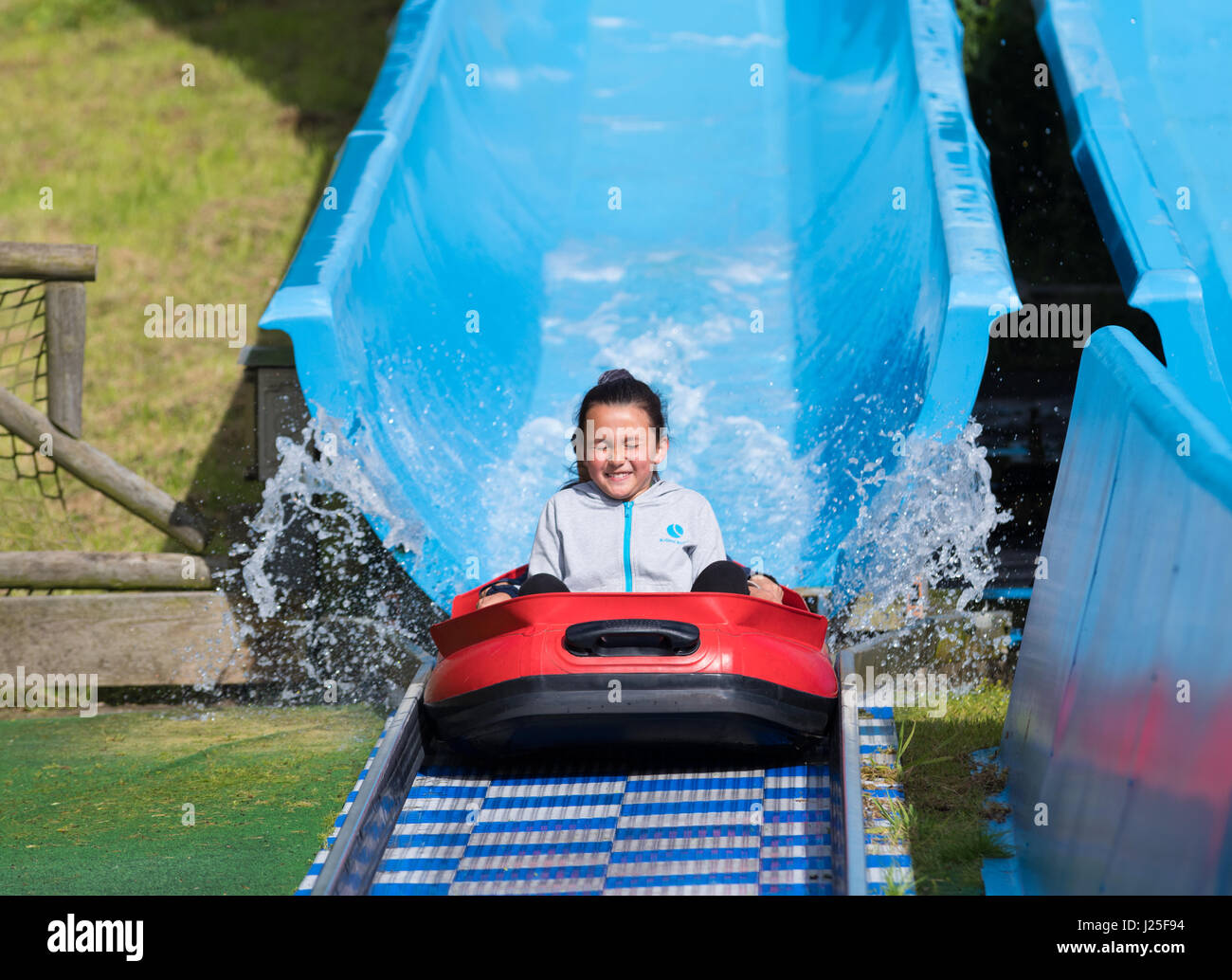 THE HAGUE, NETHERLANDS - JULI 3, 2016: Girl enjoying a water slide in a ...