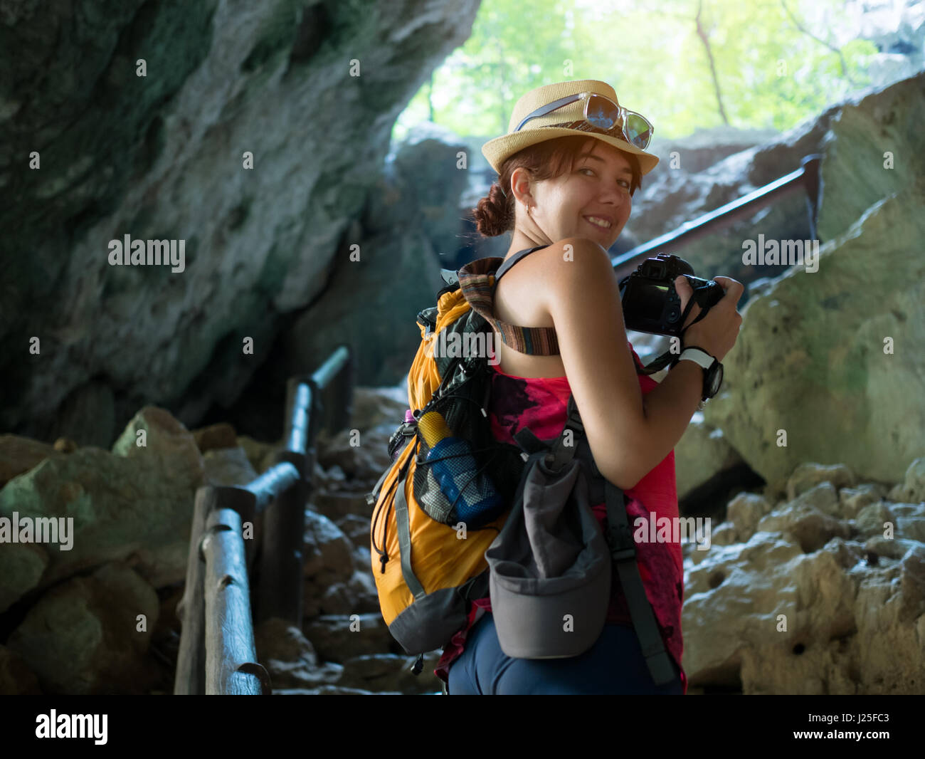 Girl with camera in cave Stock Photo - Alamy