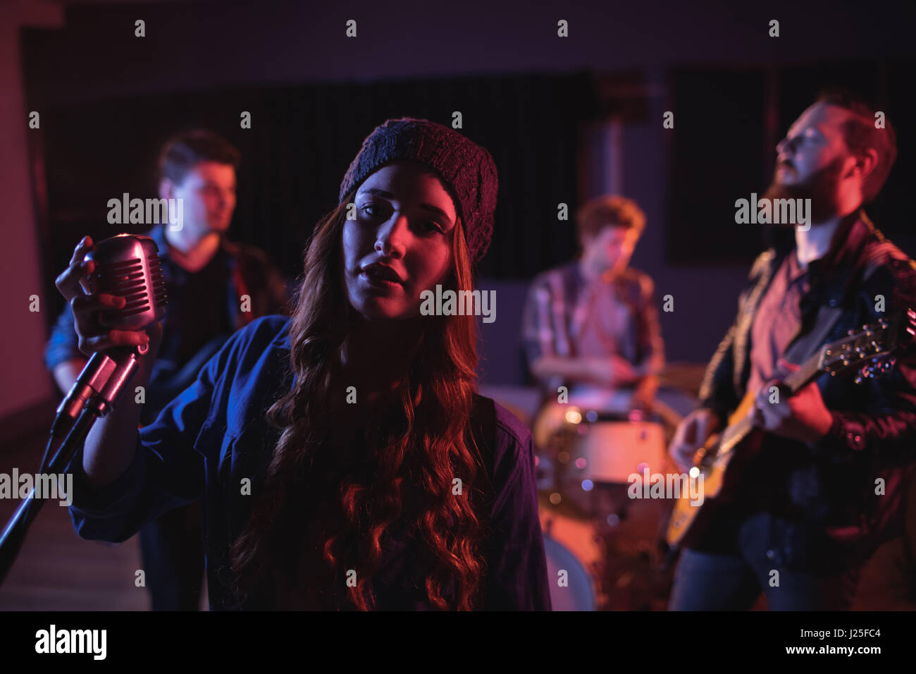 Band mates performing together in recording studio Stock Photo - Alamy