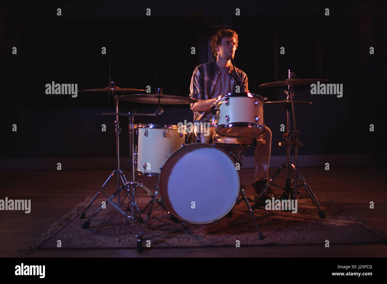 Drummer playing on drum set in recording studio Stock Photo - Alamy