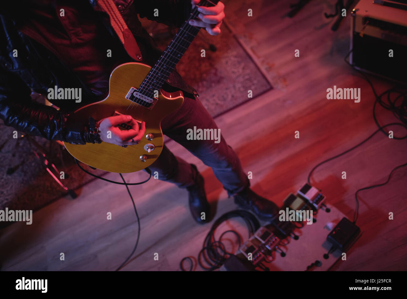 Close-up of guitarist playing electric guitar in recording studio Stock ...