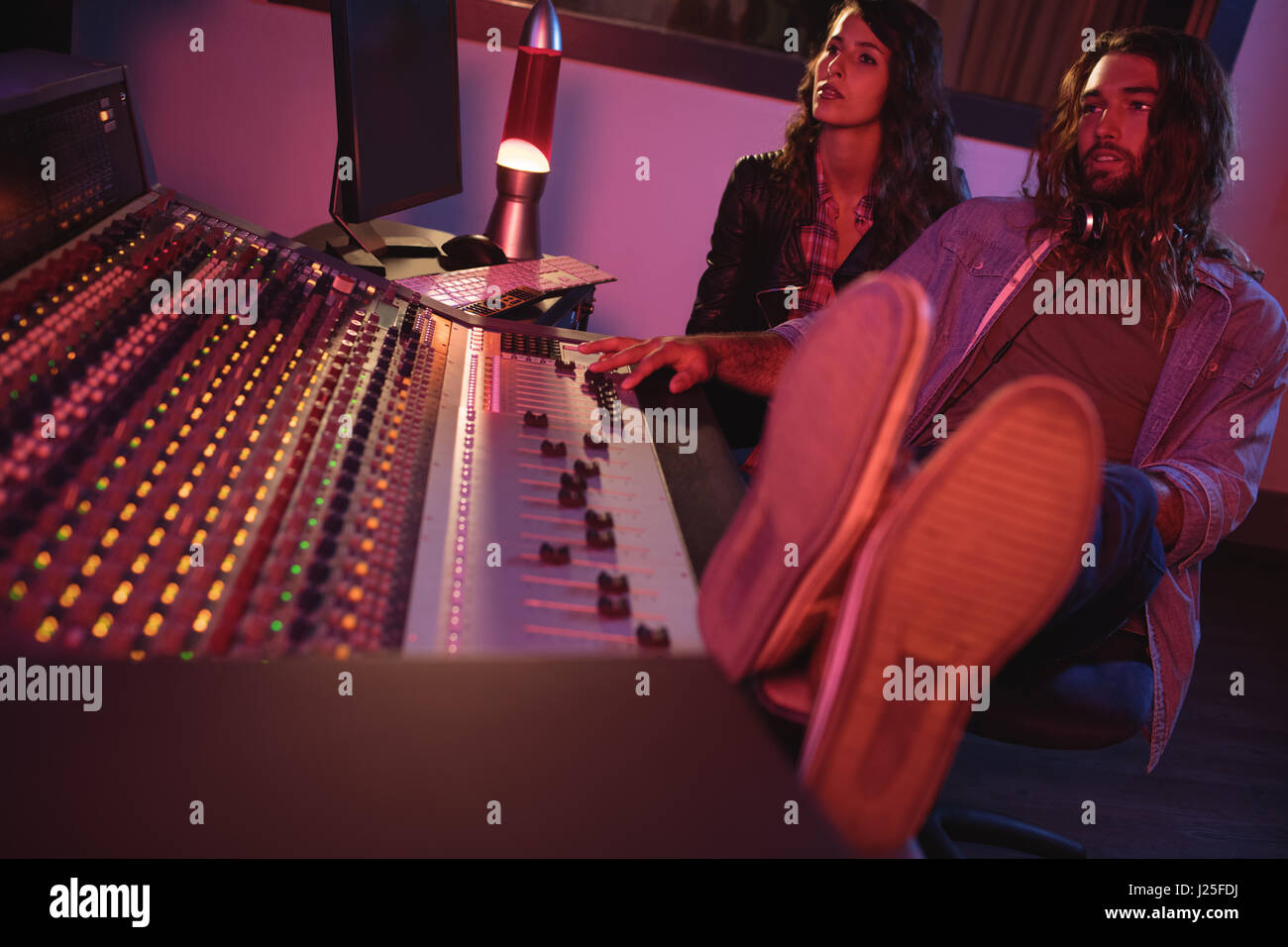 Audio engineers using sound mixer in recording studio Stock Photo - Alamy