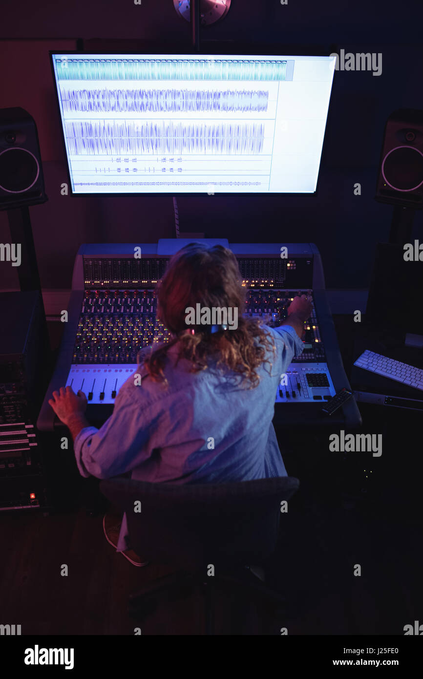 Male audio engineer using sound mixer in recording studio Stock Photo ...