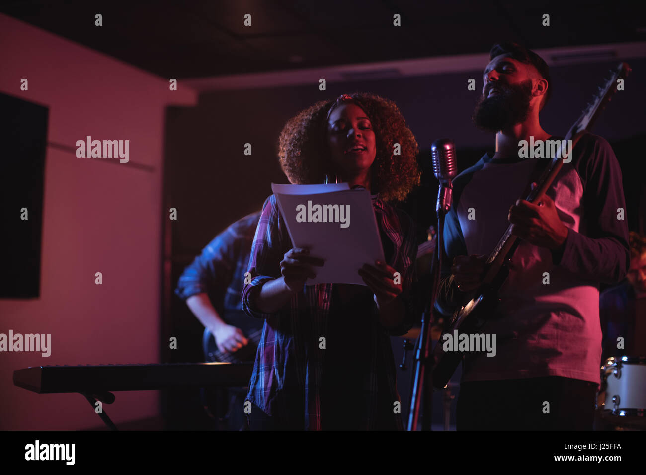 Band performing in recording studio Stock Photo - Alamy