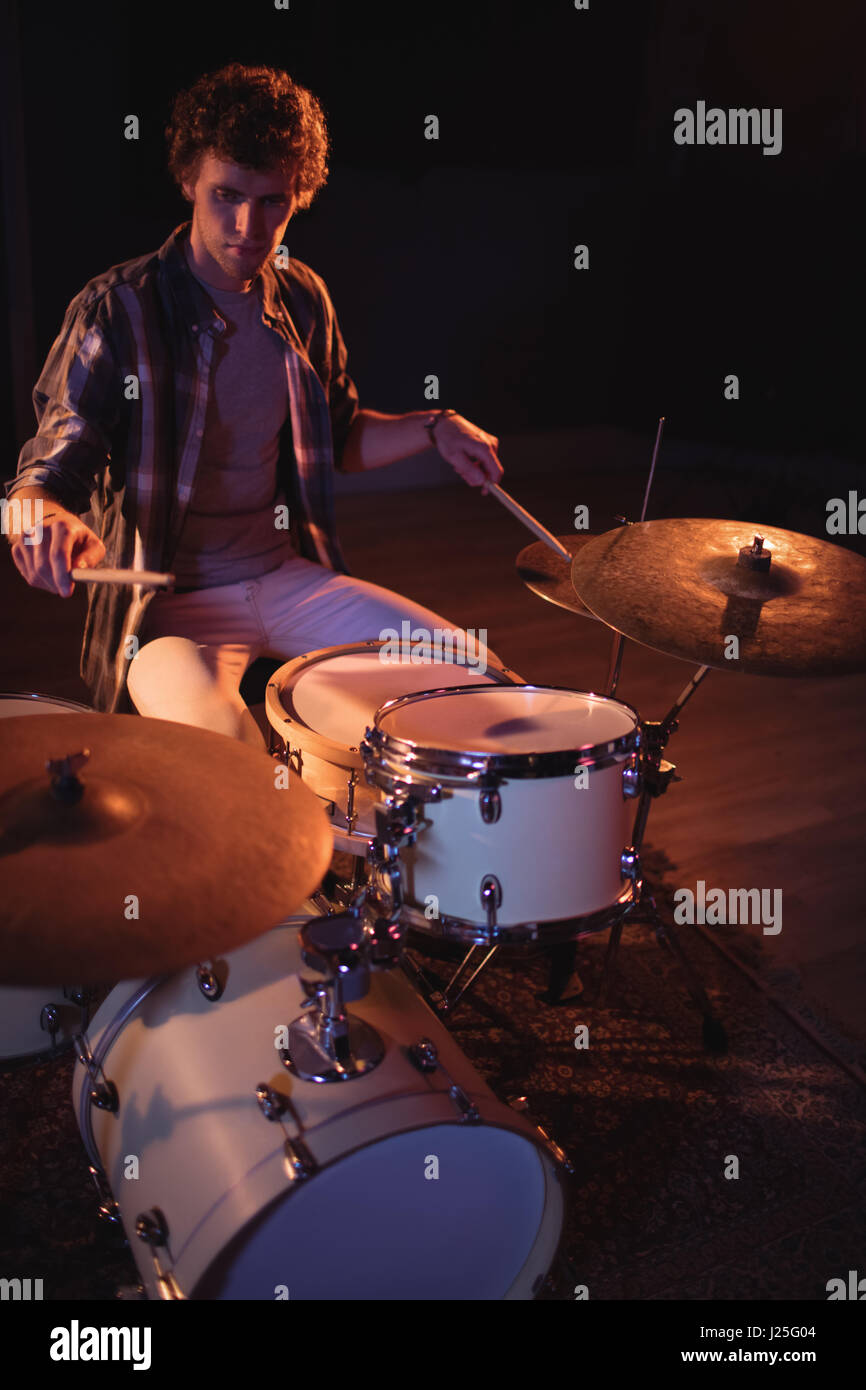 Drummer playing on drum set in recording studio Stock Photo - Alamy