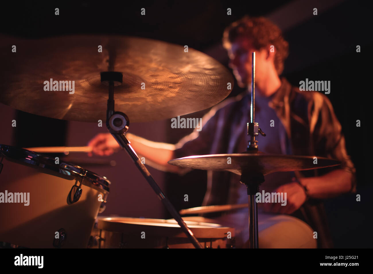 Drummer playing on drum set in recording studio Stock Photo - Alamy