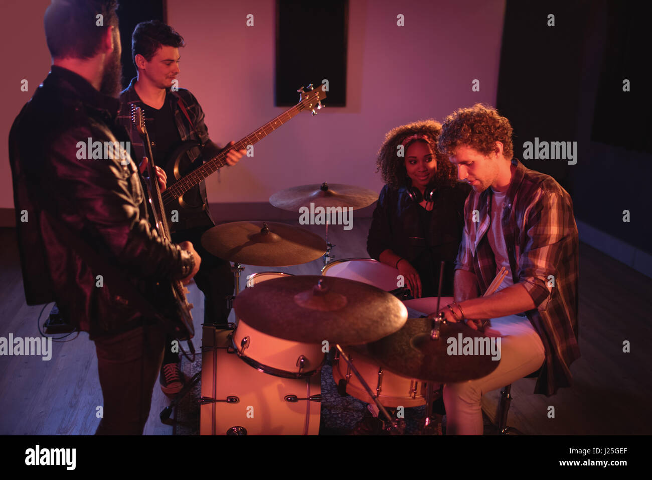 Band mates performing together in recording studio Stock Photo - Alamy