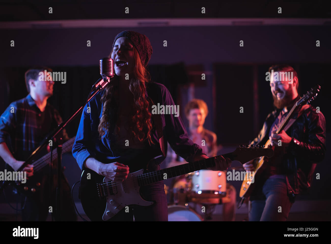 Band mates performing together in recording studio Stock Photo - Alamy