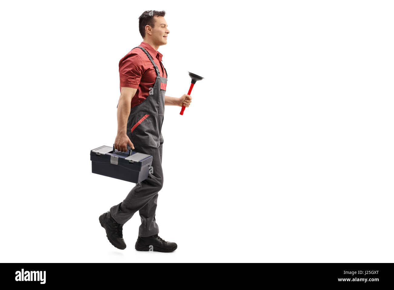 Full length profile shot of a plumber holding a plunger and a toolbox ...