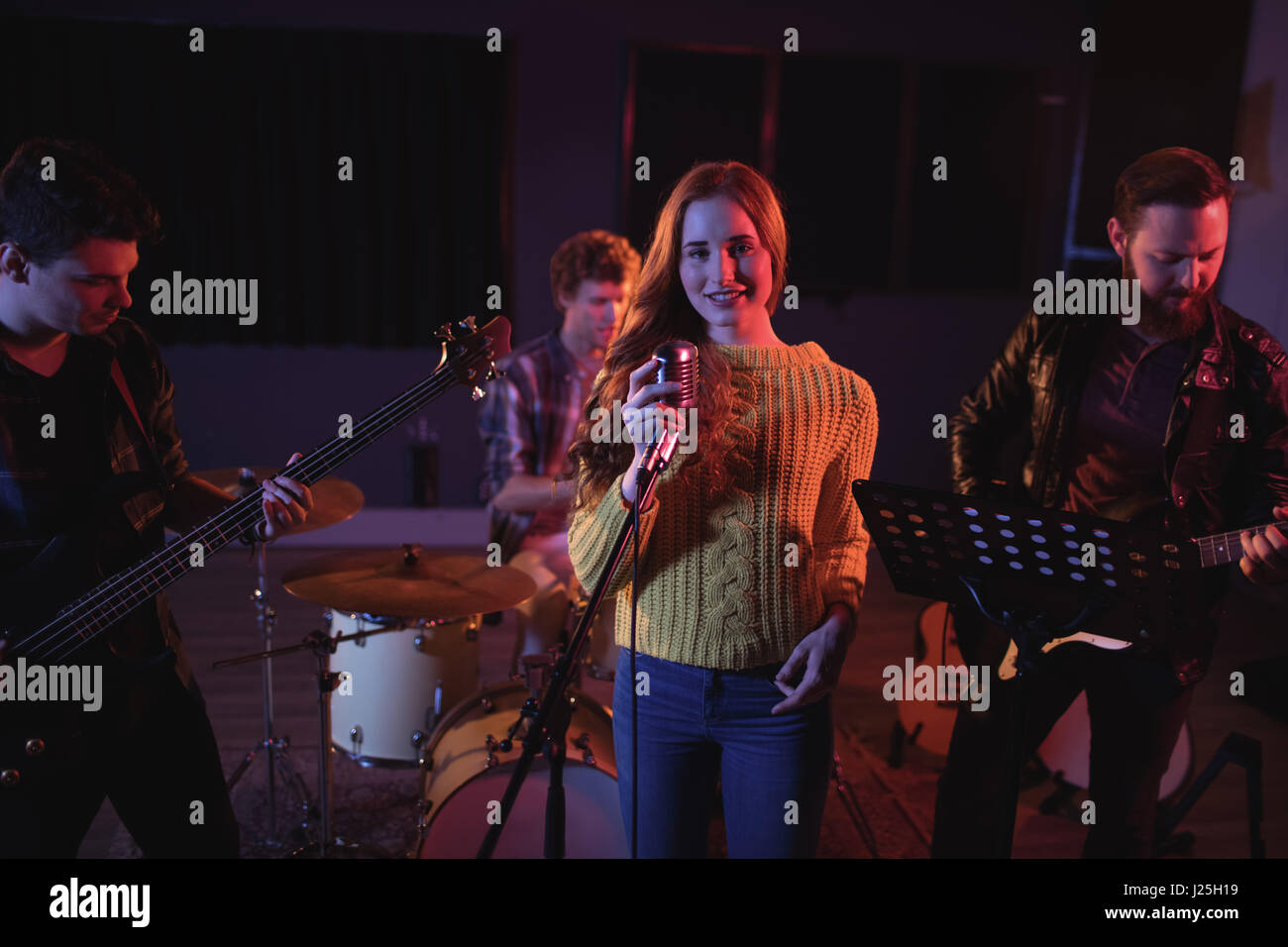 Band mates performing together in recording studio Stock Photo - Alamy