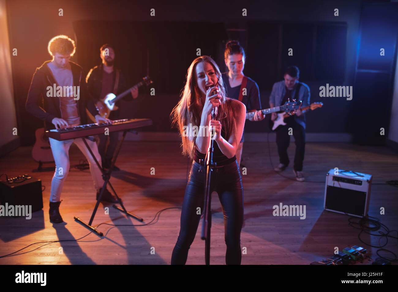 Band performing in recording studio Stock Photo - Alamy