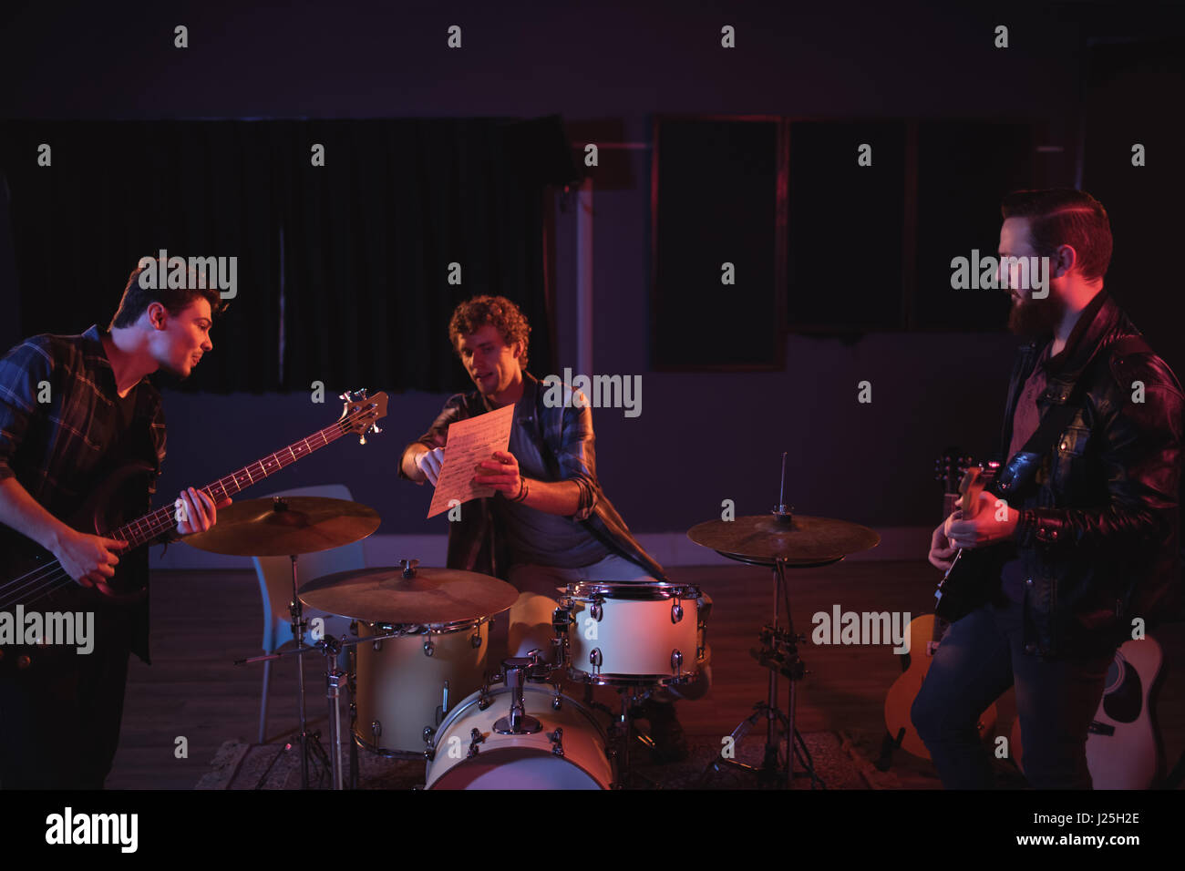 Band mates performing together in recording studio Stock Photo - Alamy