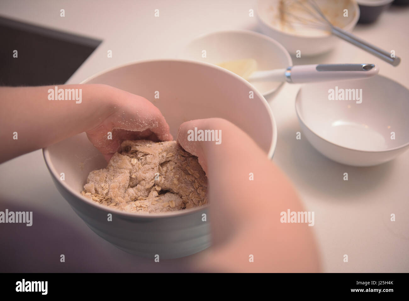 Cropped image of baker preparing batter in bowl Stock Photo - Alamy
