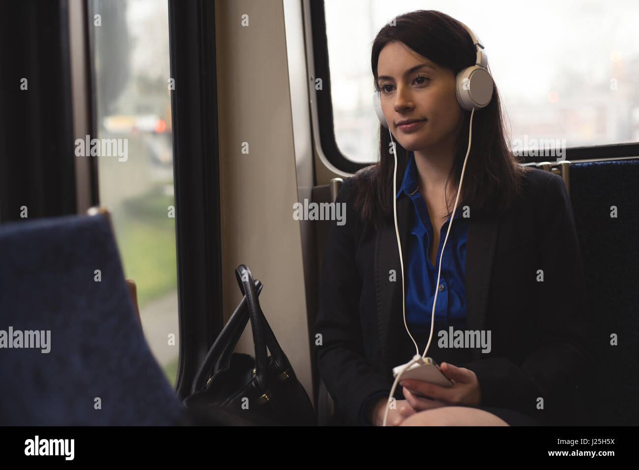 Woman with headphone in train hi-res stock photography and images - Alamy