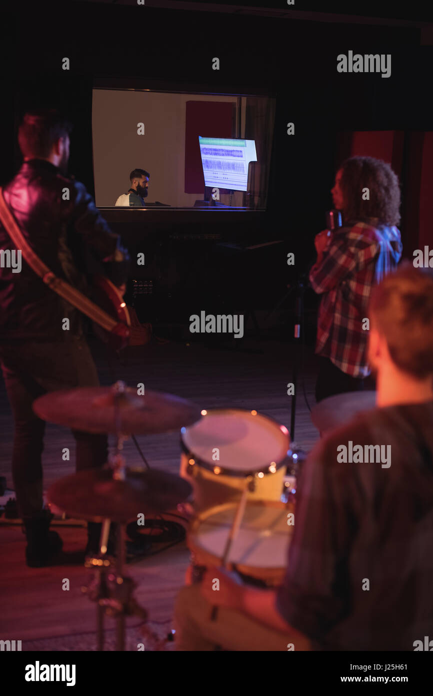 Rear view of band performing in recording studio Stock Photo - Alamy