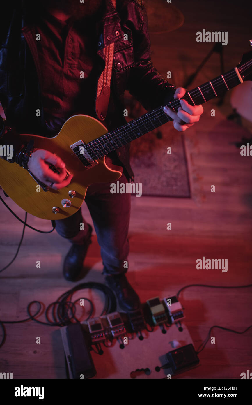 Close-up of guitarist playing electric guitar in recording studio Stock ...