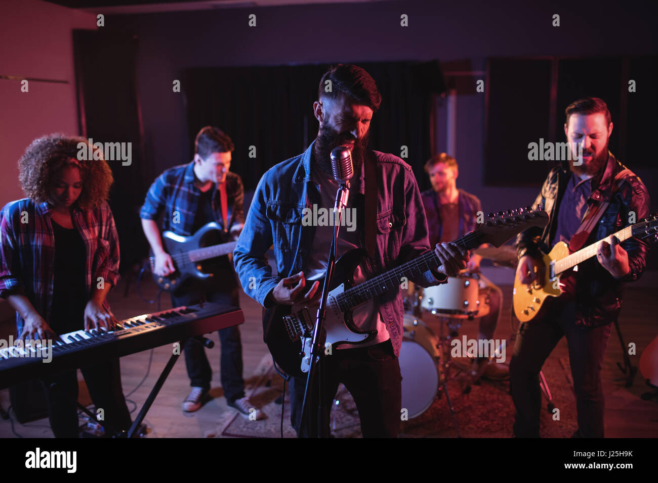 Band performing in recording studio Stock Photo - Alamy