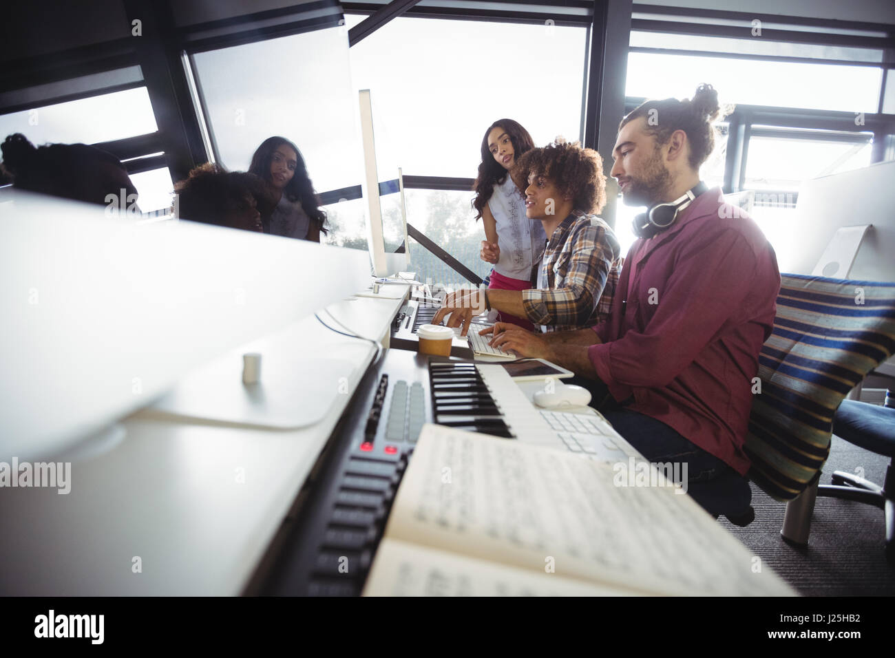 Three sound engineers working together in studio Stock Photo - Alamy