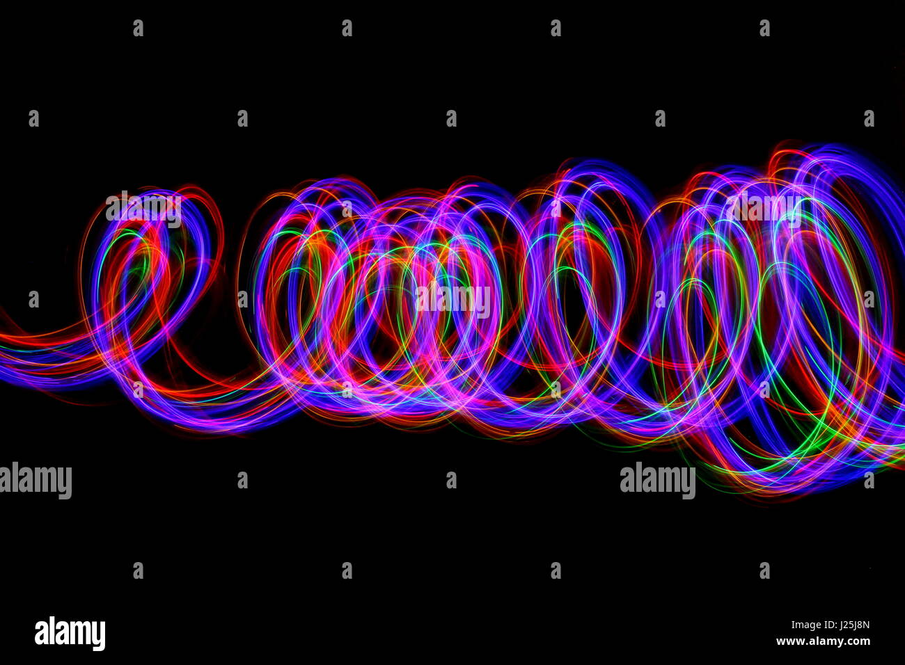 Long exposure photograph of neon multi-colour in an abstract pattern ...