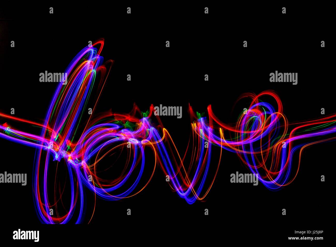 Long exposure photograph of neon multi-colour writing word 'love ...