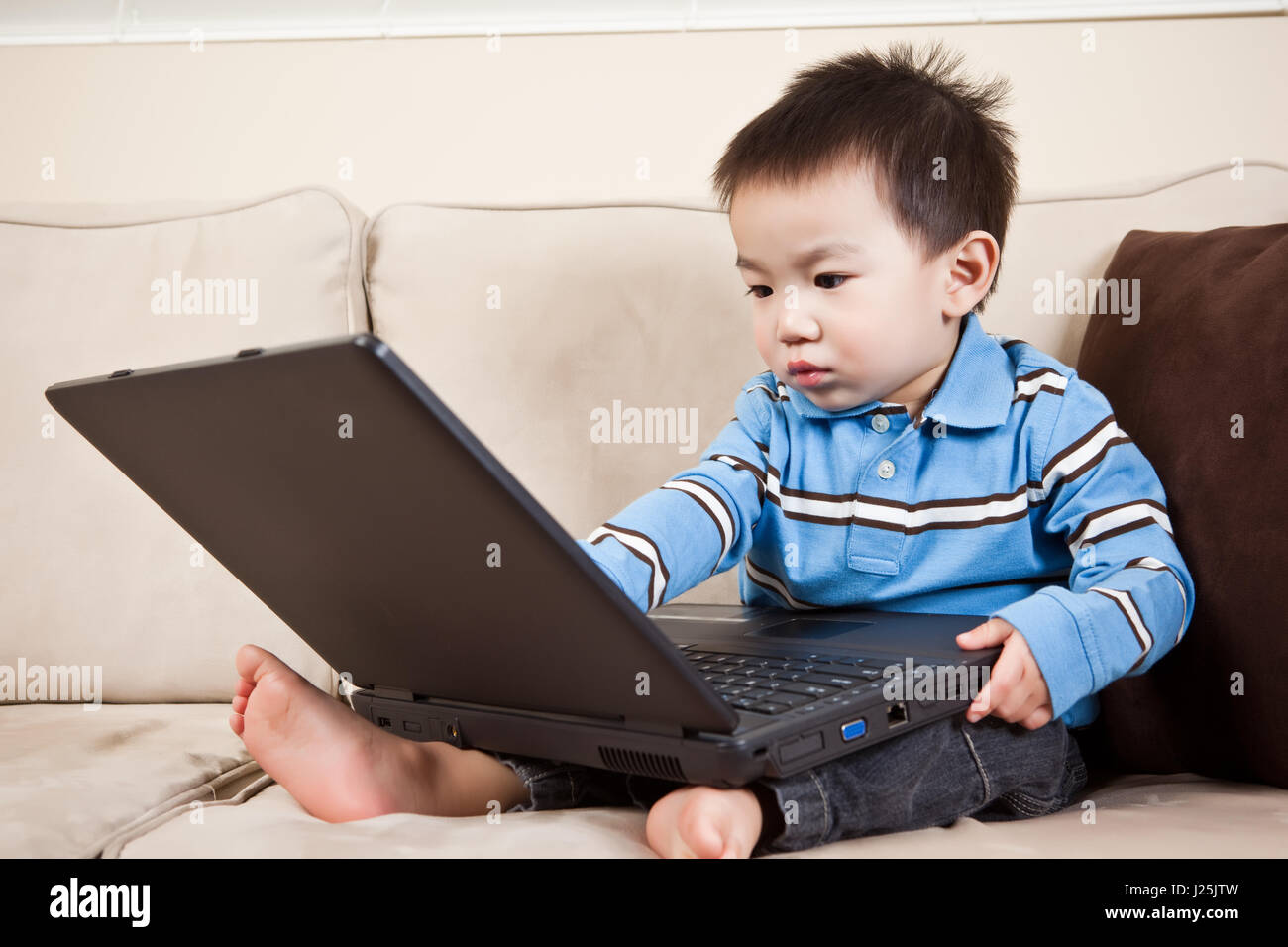 A portrait of an asian boy using a laptop Stock Photo - Alamy
